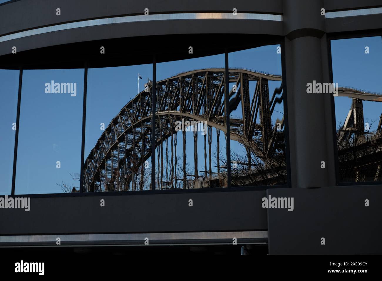 The Arch of the Sydney Harbour Bridge reflected and distorted in a row ...