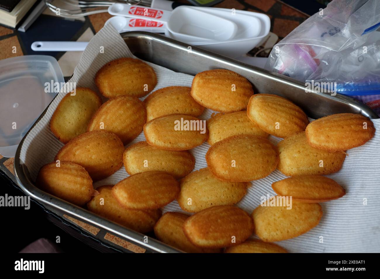 Home made Madeleine cakes turned out onto paper towel on for cooling on ...