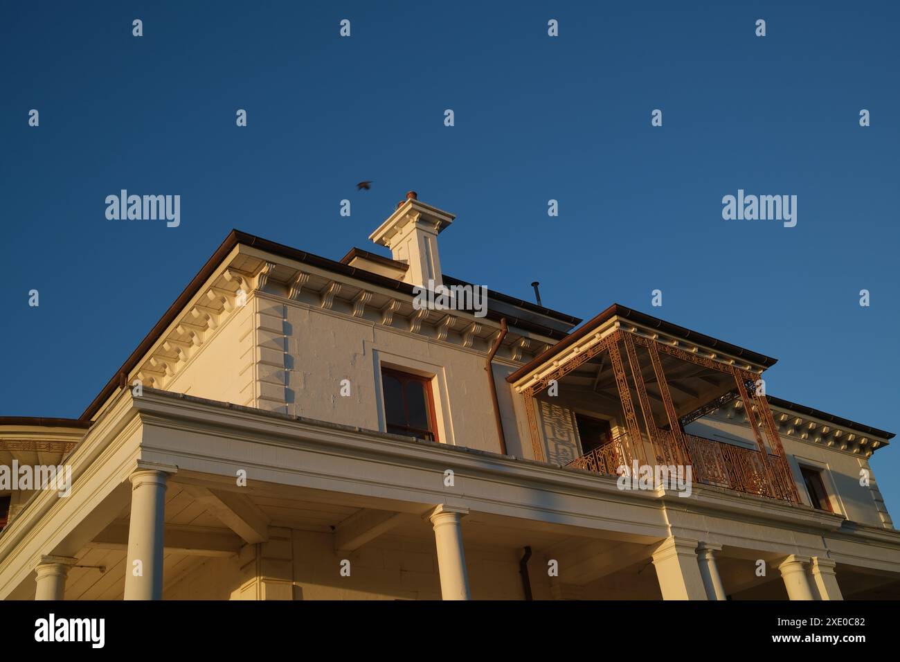 Looking up at the cast iron columns, decorative iron lace and roofline ...