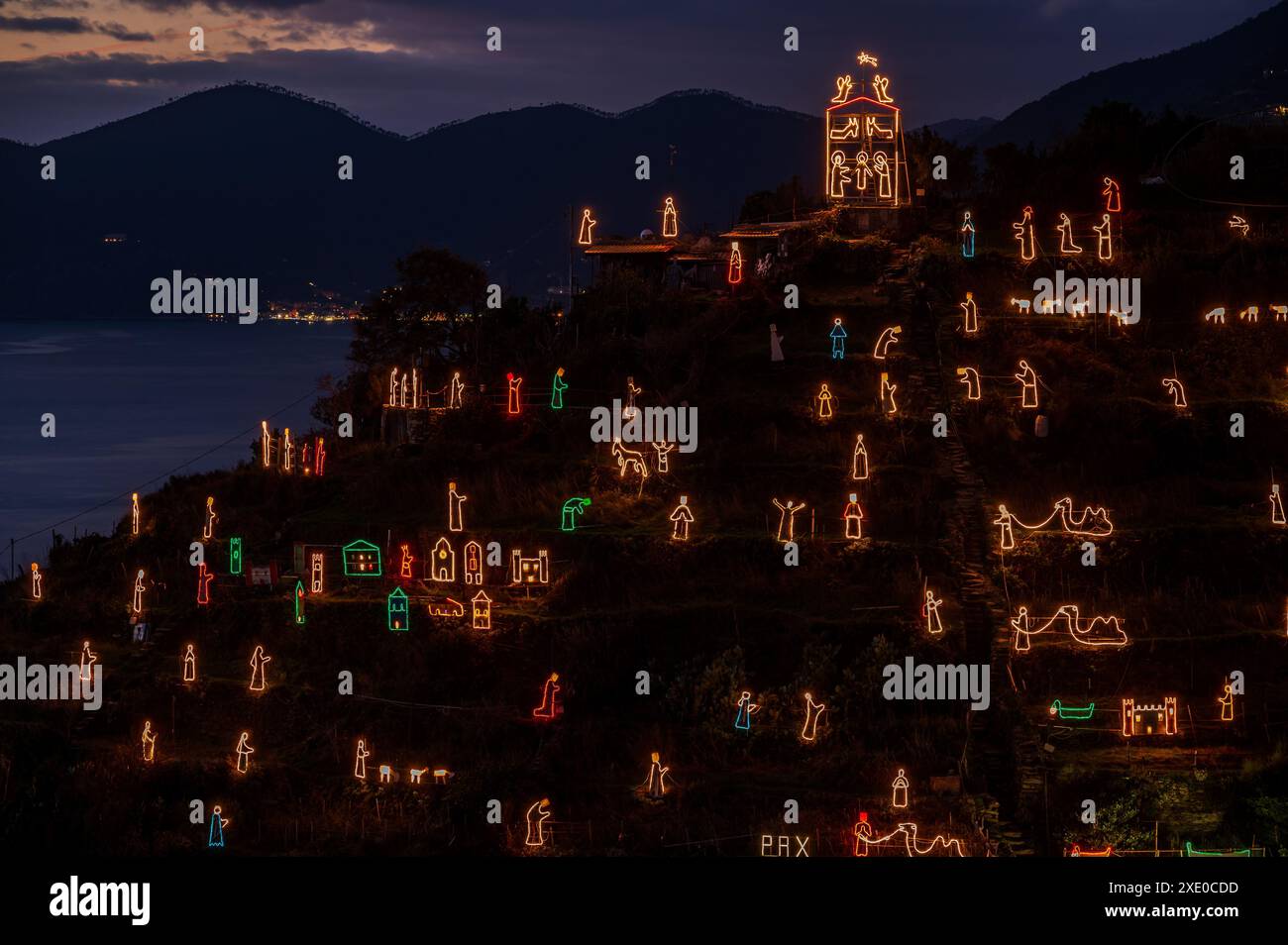 Illuminated Nativity Scene on the top of a Hill over the village of ...