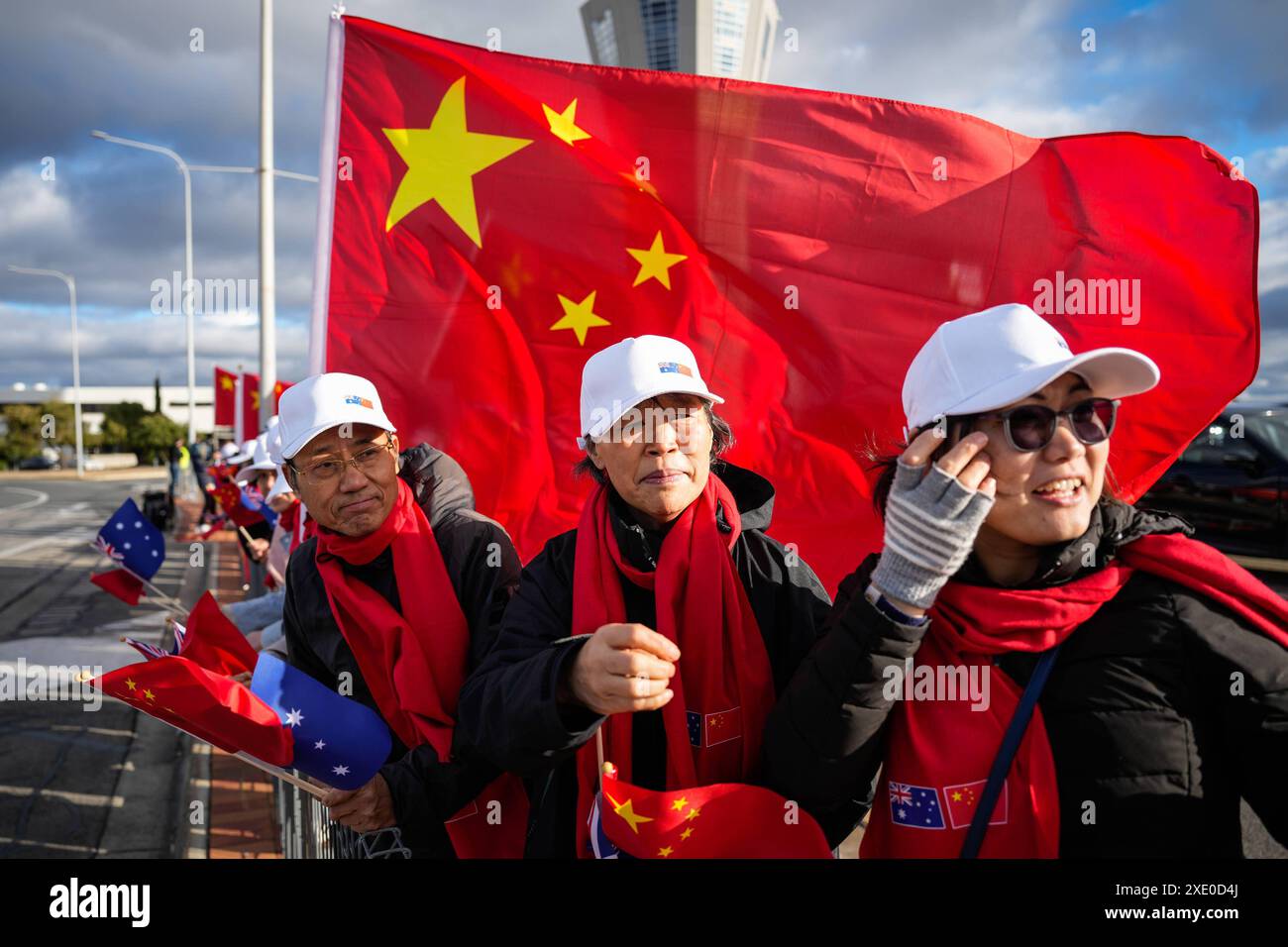 People wave Chinese national flags as they await the arrival of China s ...