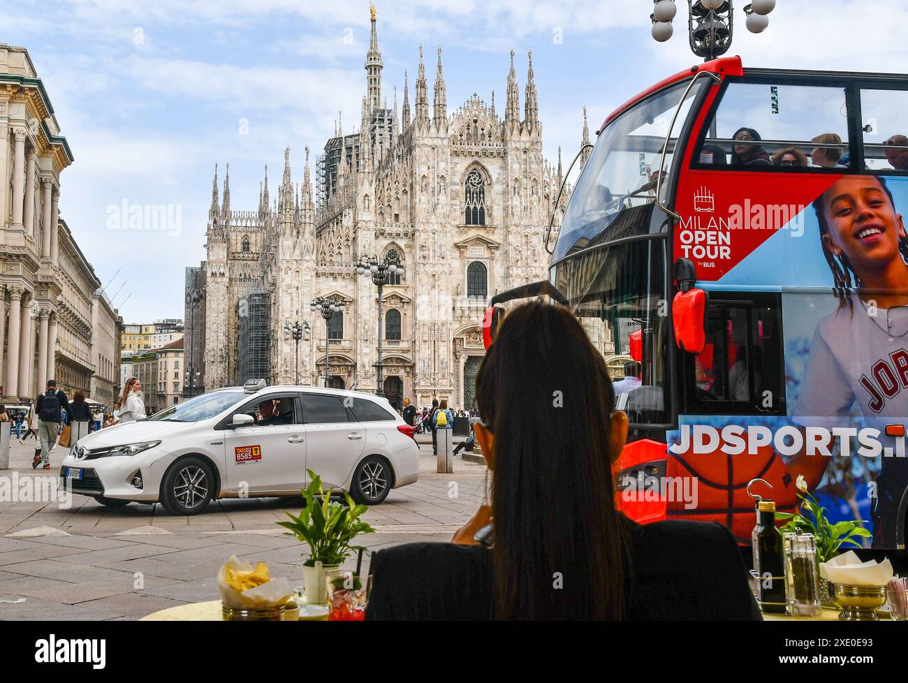 View from an outdoor bar of Piazza del Duomo with a girl from behind, a ...