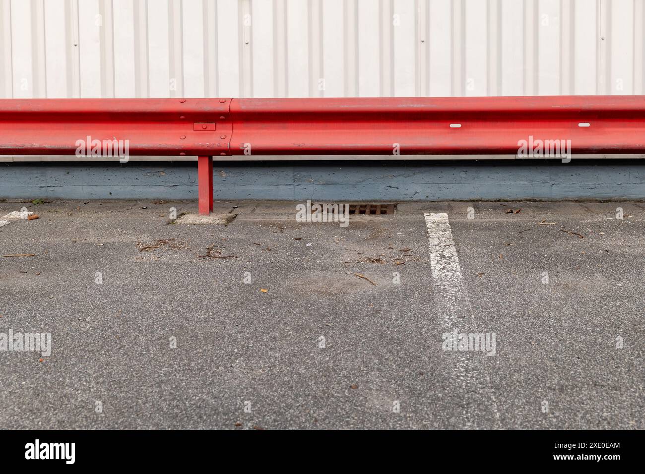Red guardrail in a parking lot Stock Photo - Alamy