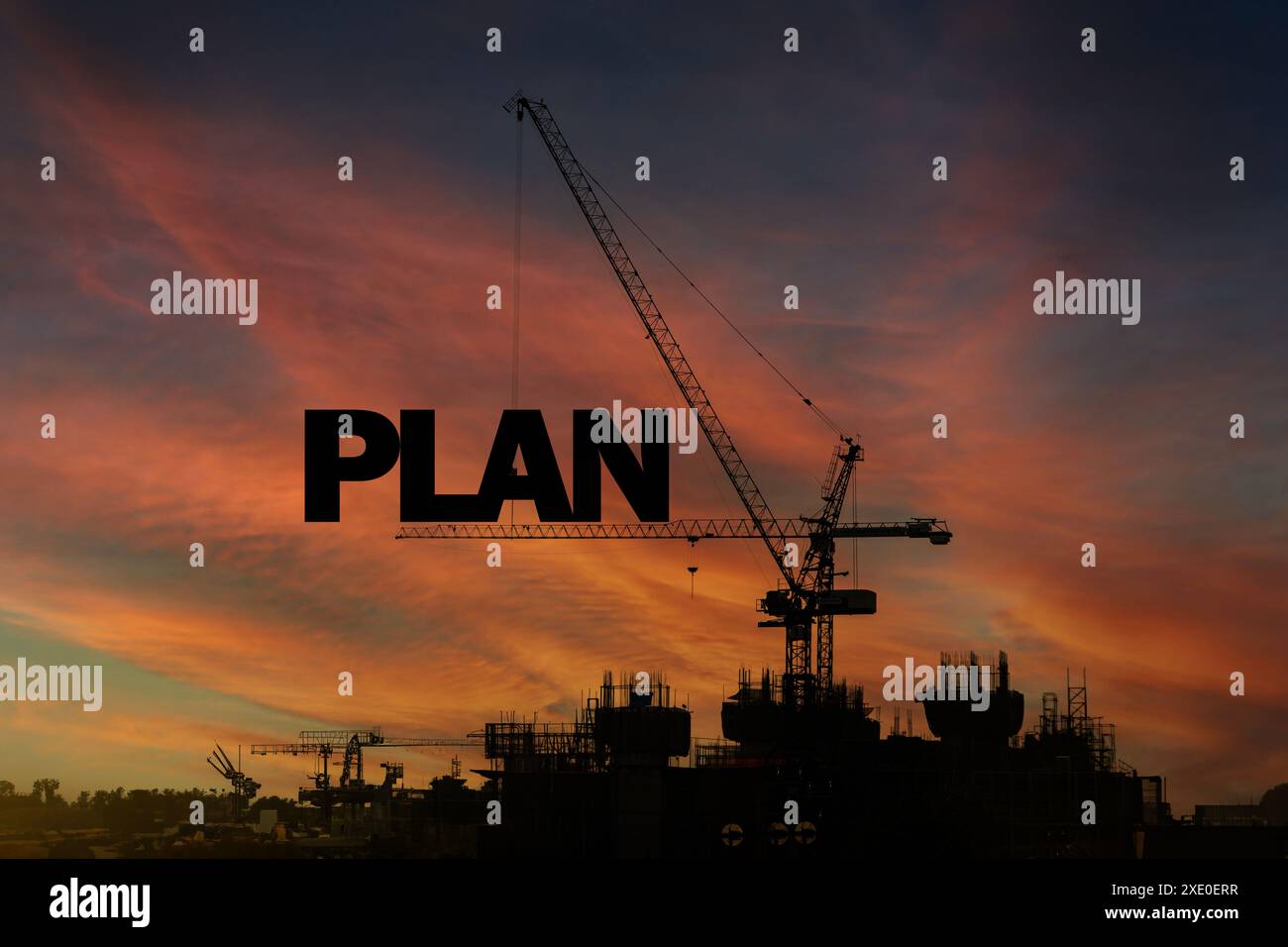 A construction site with the word PLAN written on a crane. The crane is ...