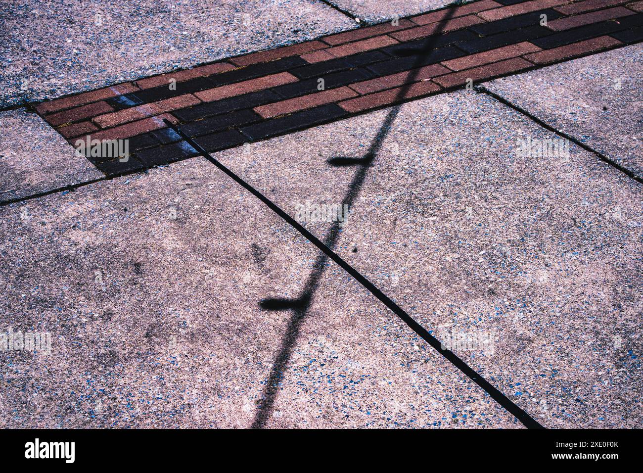 Looking down on shapes and shadows on the pavement Stock Photo - Alamy