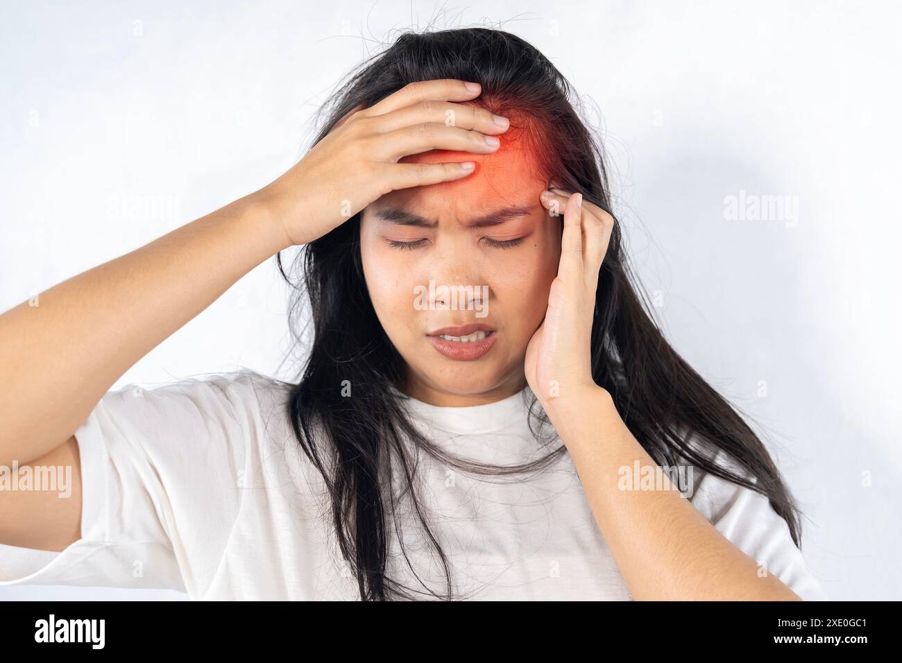 Asian girl with headache holding her head. monochrome image with red ...