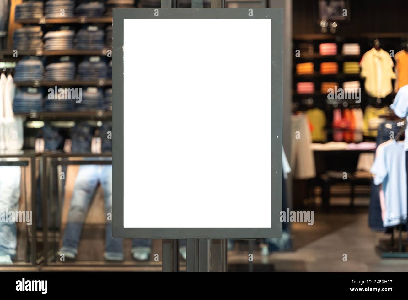 Vertical white sign on the front of a clothing store with a glass ...