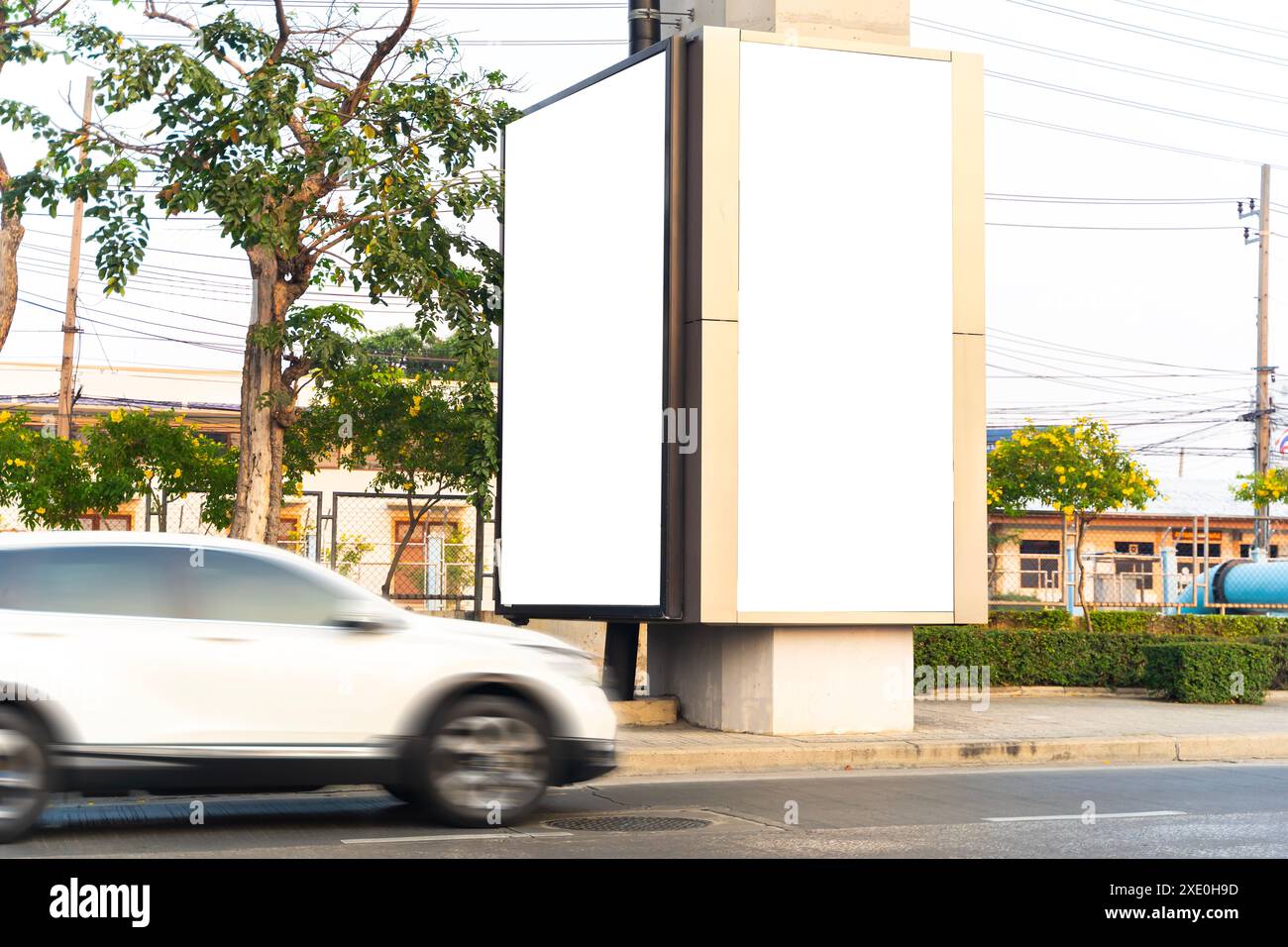 White bus stop billboard poster in a station with cars in moving in the ...