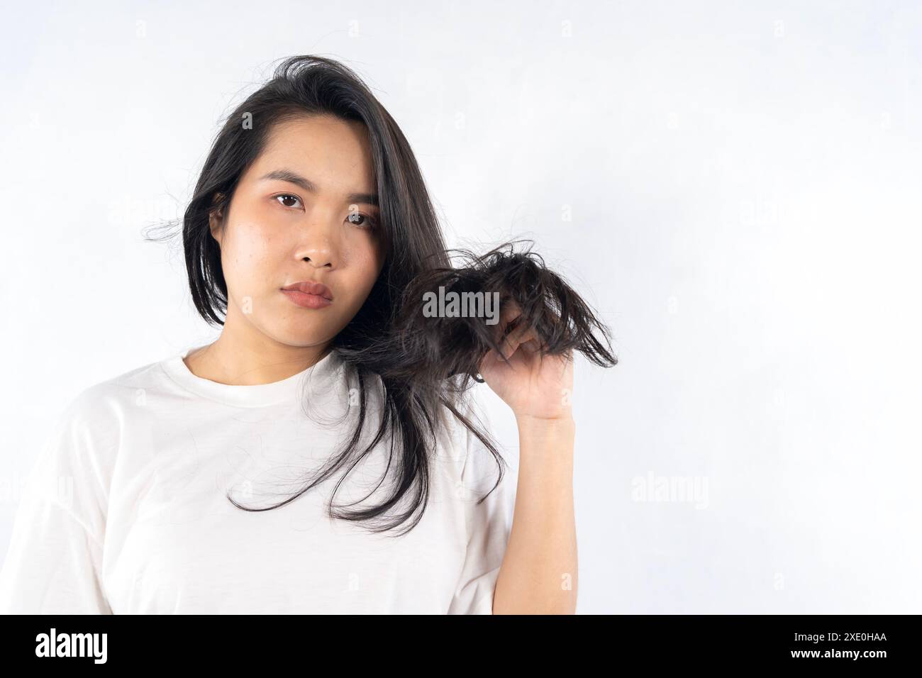 Young black woman with messy hair on white background. Asian women are ...
