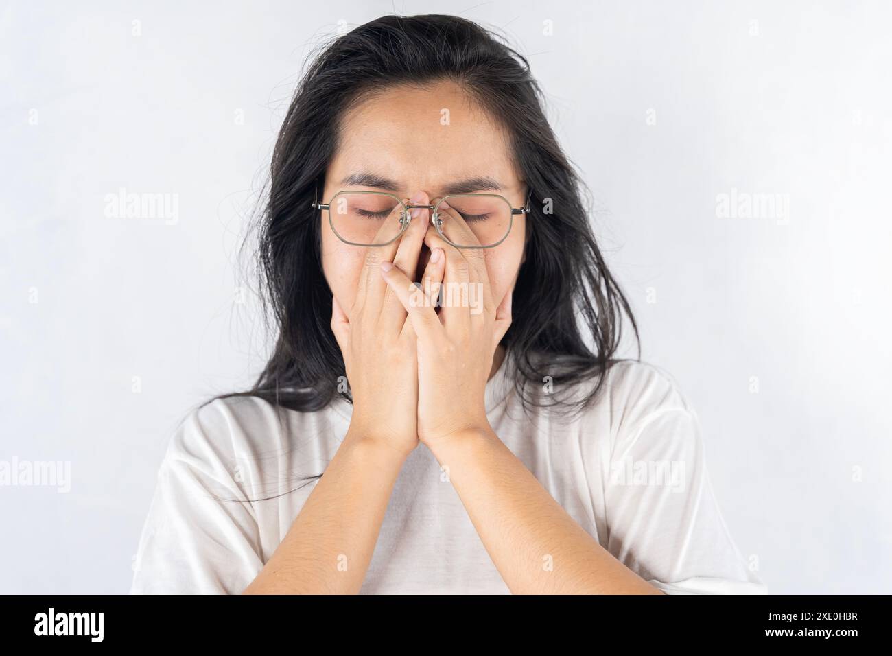 Young woman rubs her eyes after using glasses. Eye pain or fatigue ...