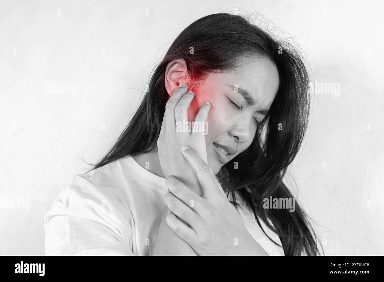 Young woman with sore ear, suffering from otitis, black and white ...