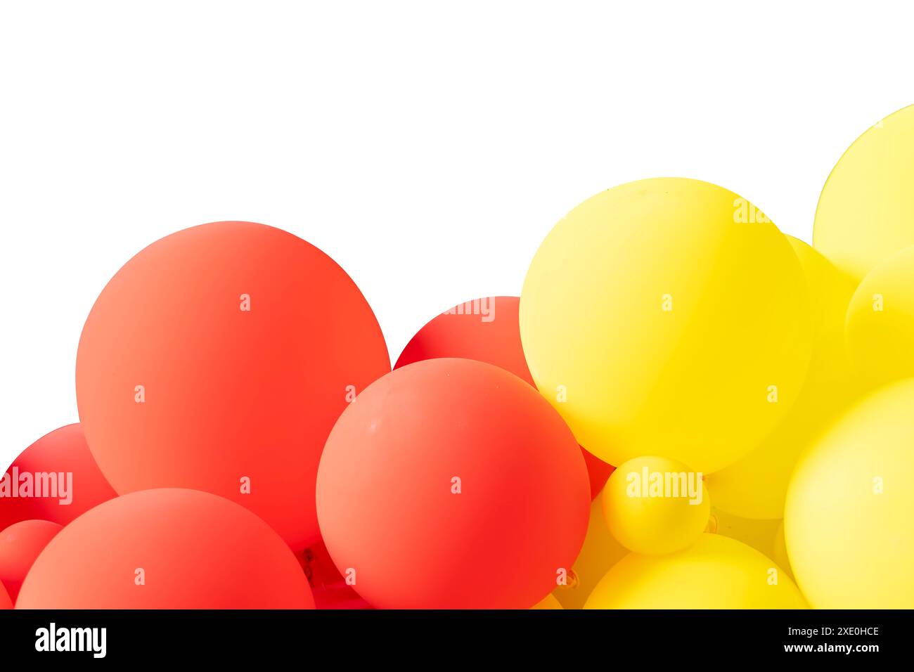 A bunch of red and yellow balloons floating on a white background. The ...