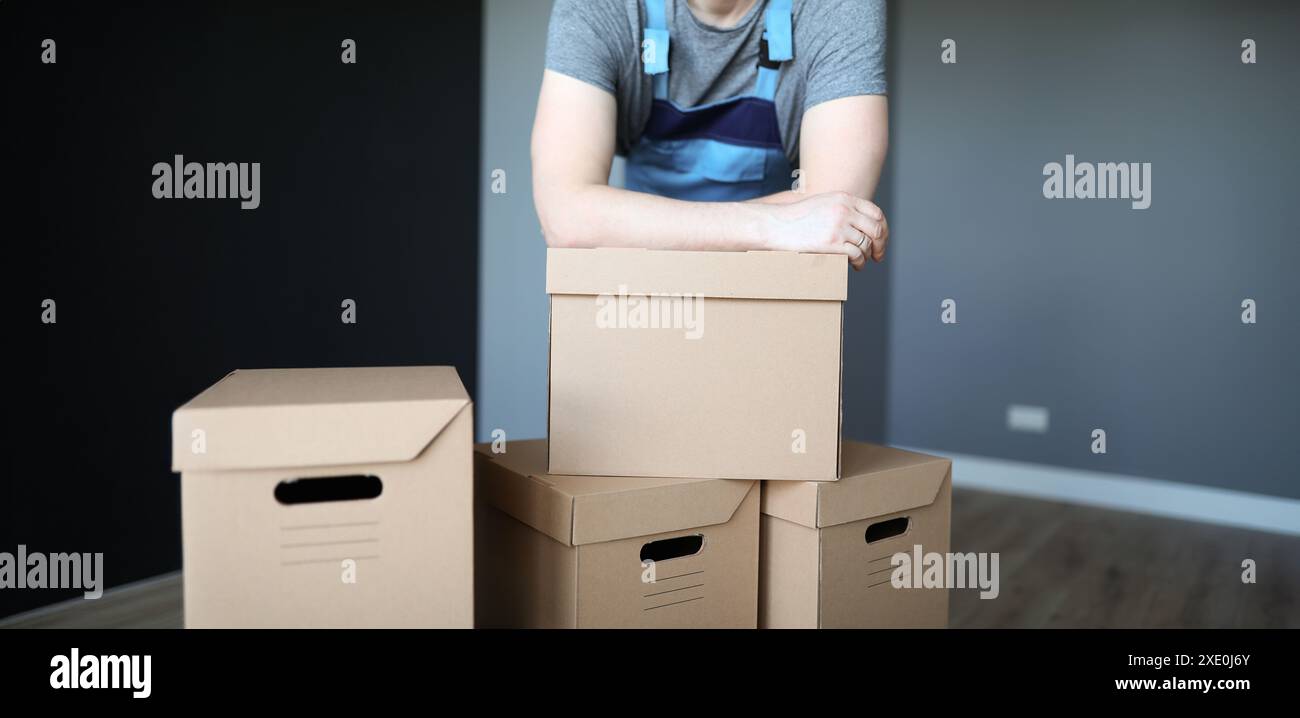 Delivery man putting carton boxes hi-res stock photography and images ...