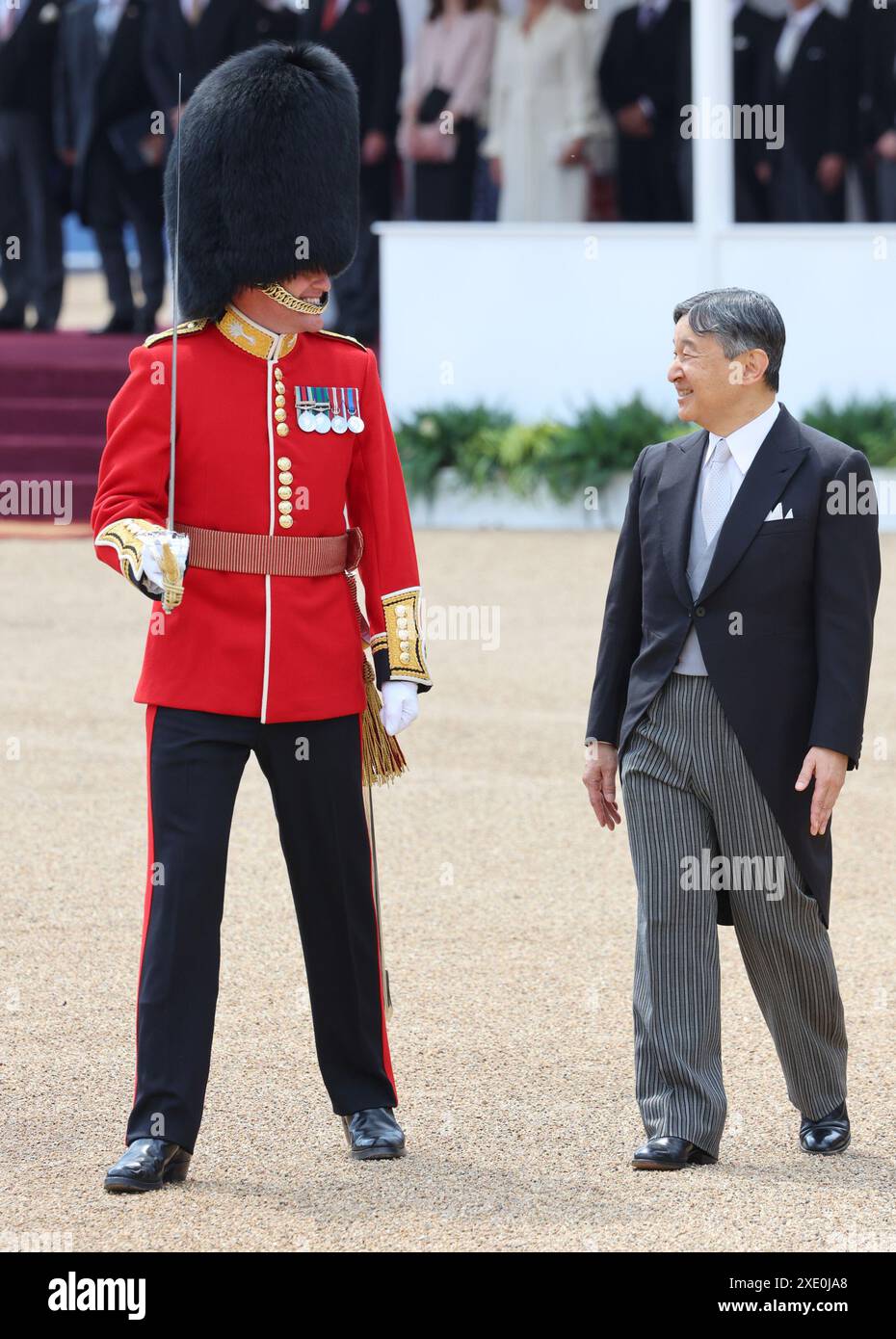 Emperor Naruhito of Japan shares a joke with an officer of the Welsh ...