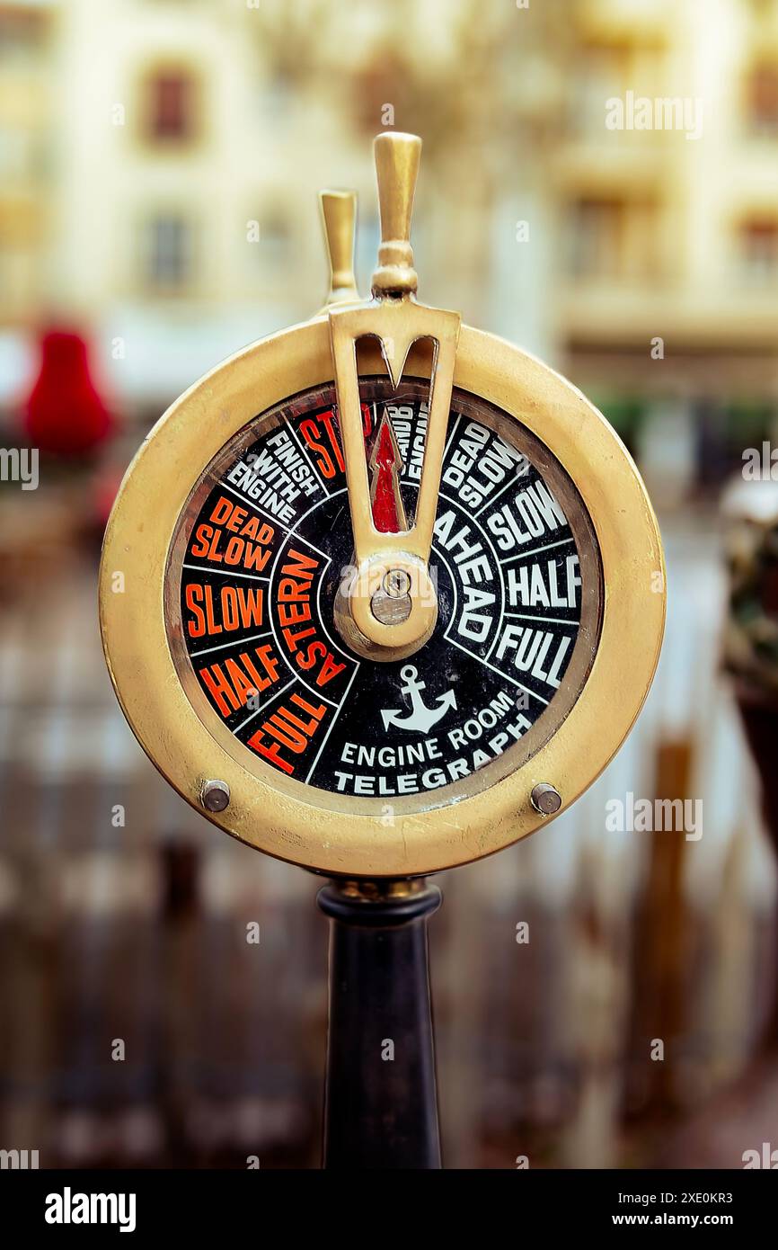 Vintage brass ship throttle with white and red lettering in an antique ...