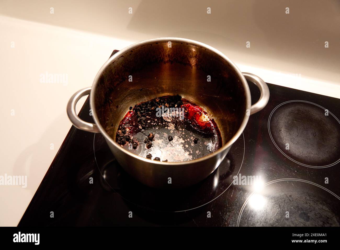 Large pot burned with chickpeas inside on the induction hob in the ...