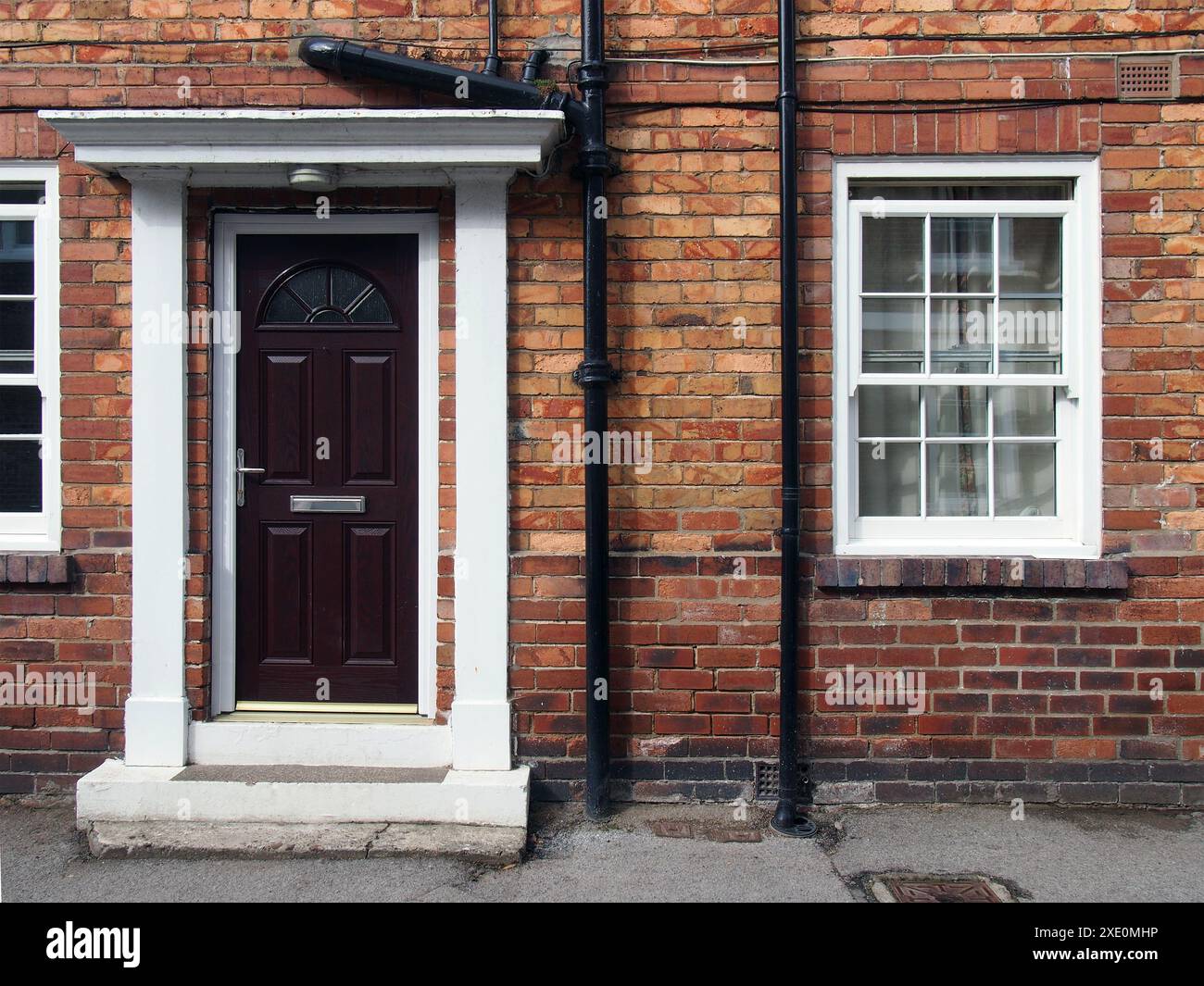 front view of a typical old small english terraced brick house with ...