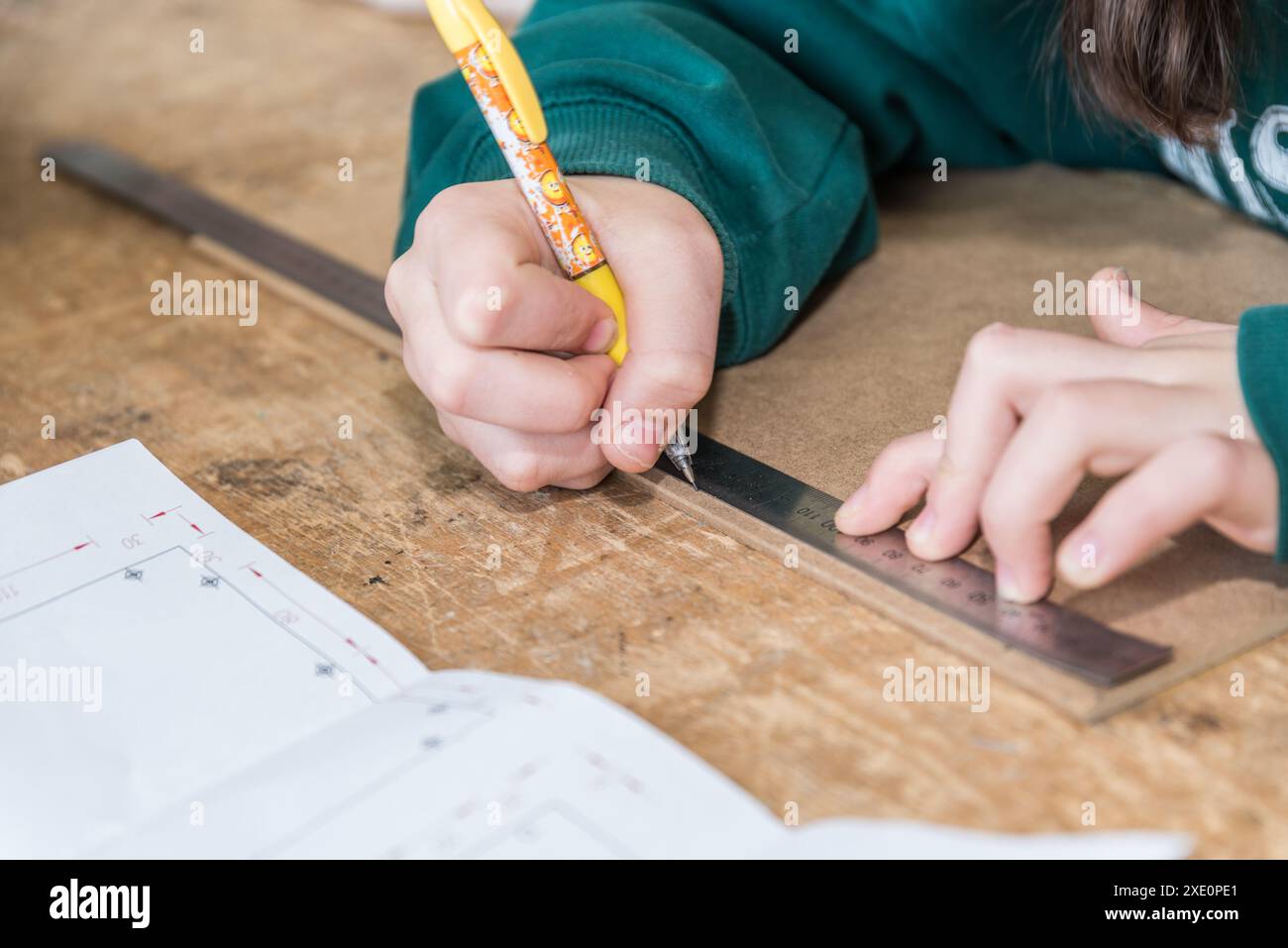Measure with metal ruler in workshop and mark with pen - craft Stock ...