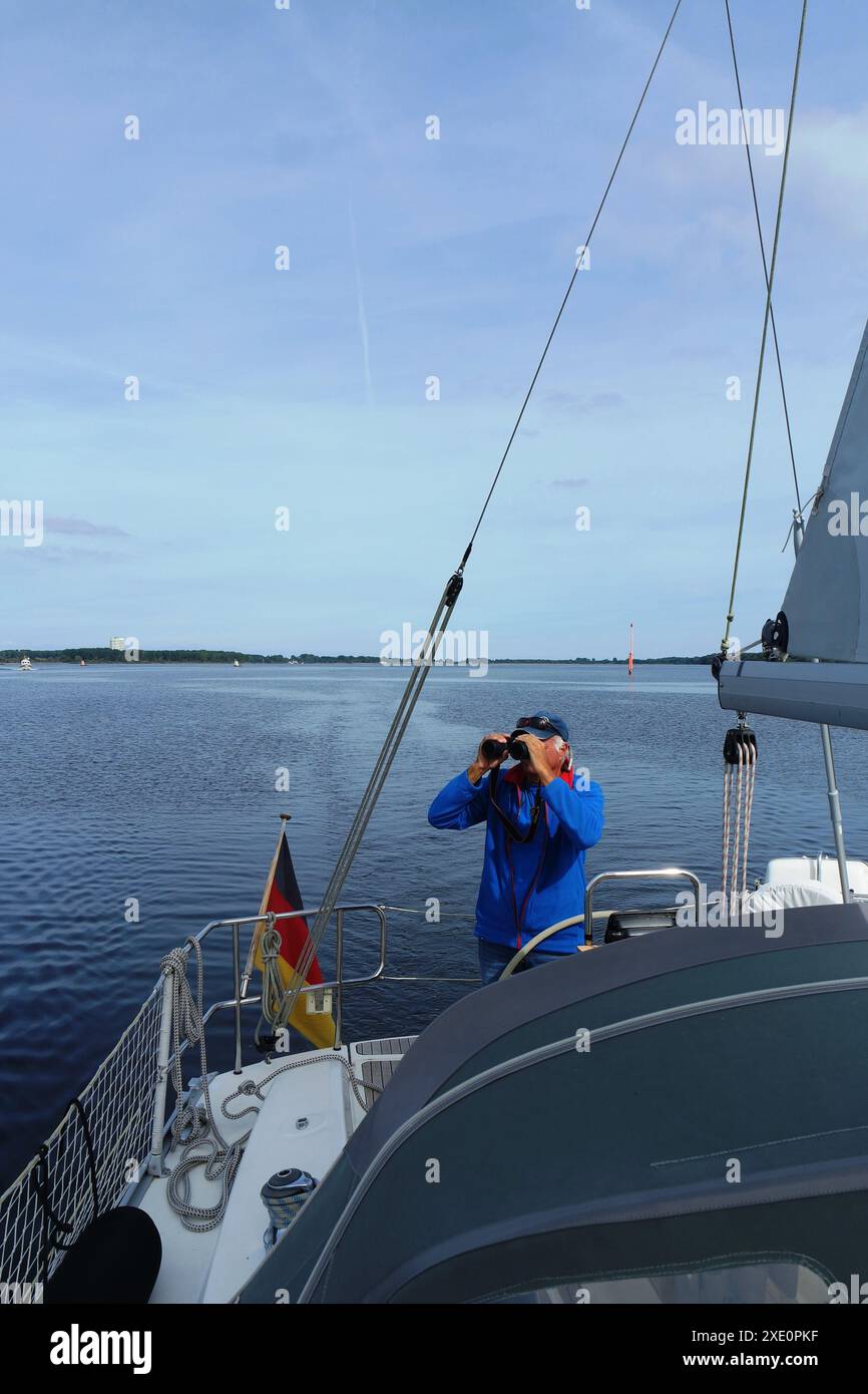 Sailing trip, skipper with binoculars Stock Photo - Alamy