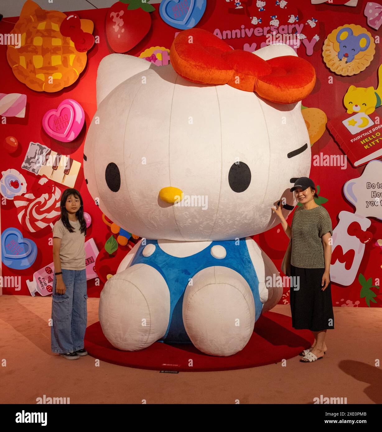 mother and daughter posing beside huge Hello Kitty 50th-Anniversary ...