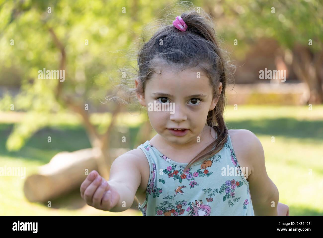 Empowered and confident little girl, looking at the camera with a ...