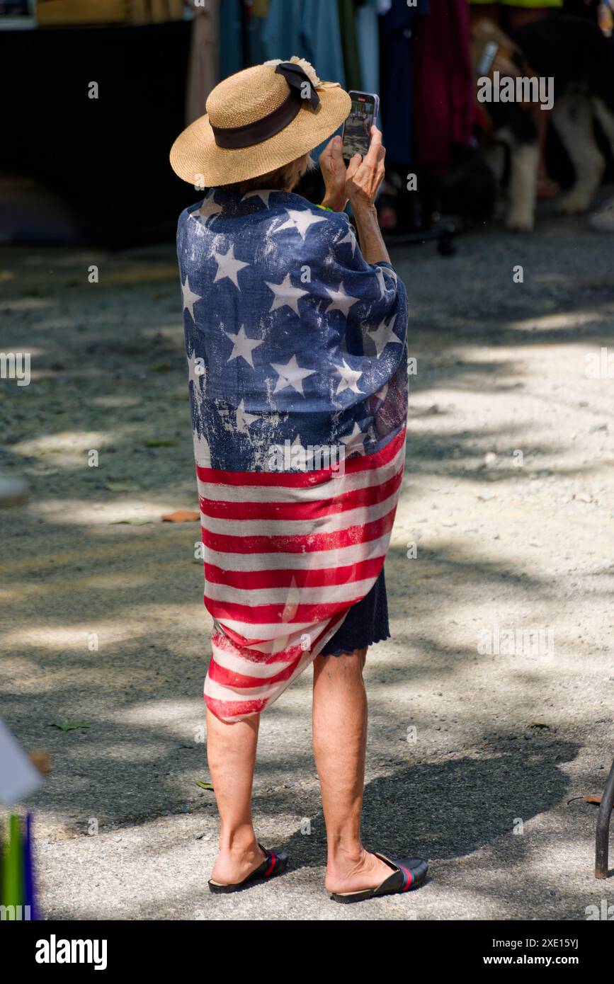 A woman patriot draped in an American flag cloth wrap. The stars and ...