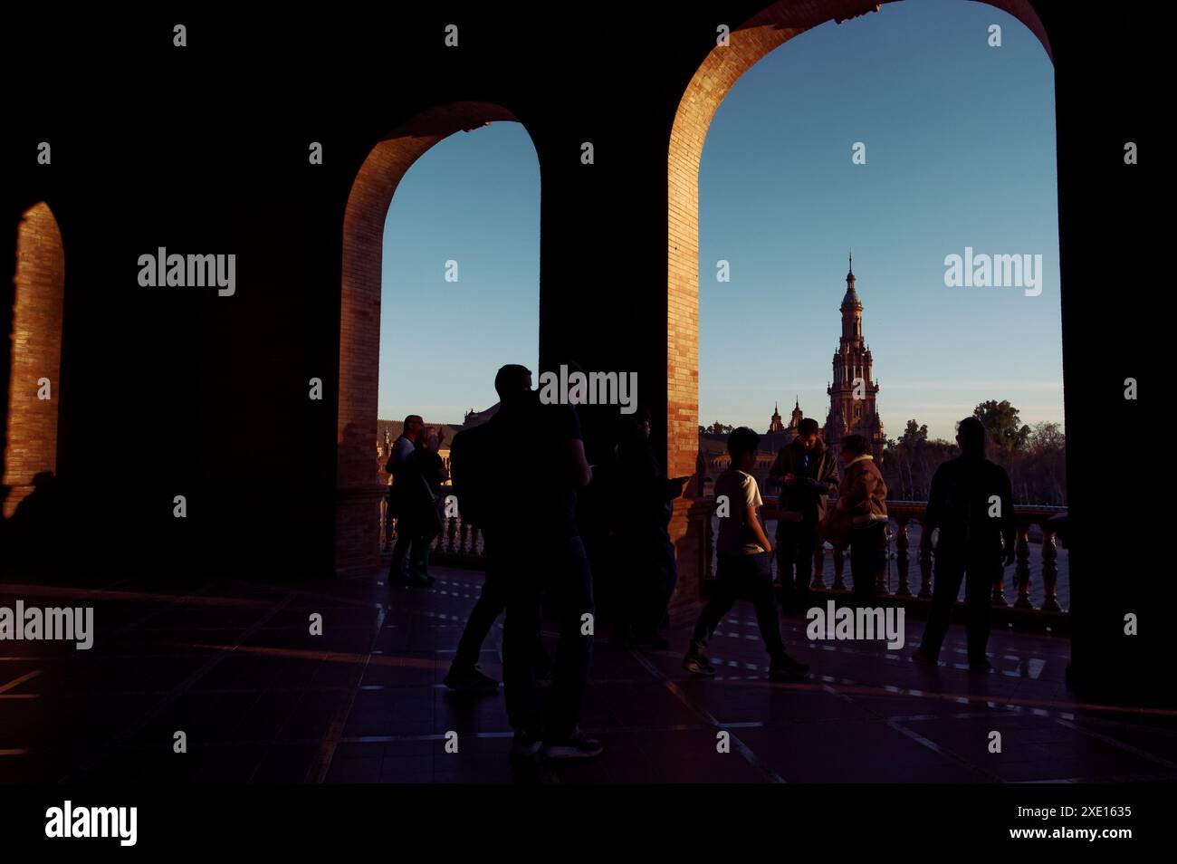 People enjoying the evening at plaza de españa in Sevilla, silhouetted ...