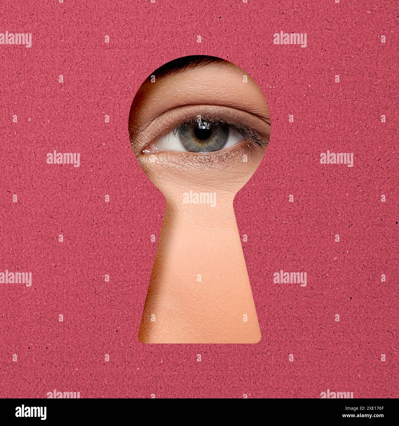 Woman looking through keyhole in crimson color surface Stock Photo - Alamy