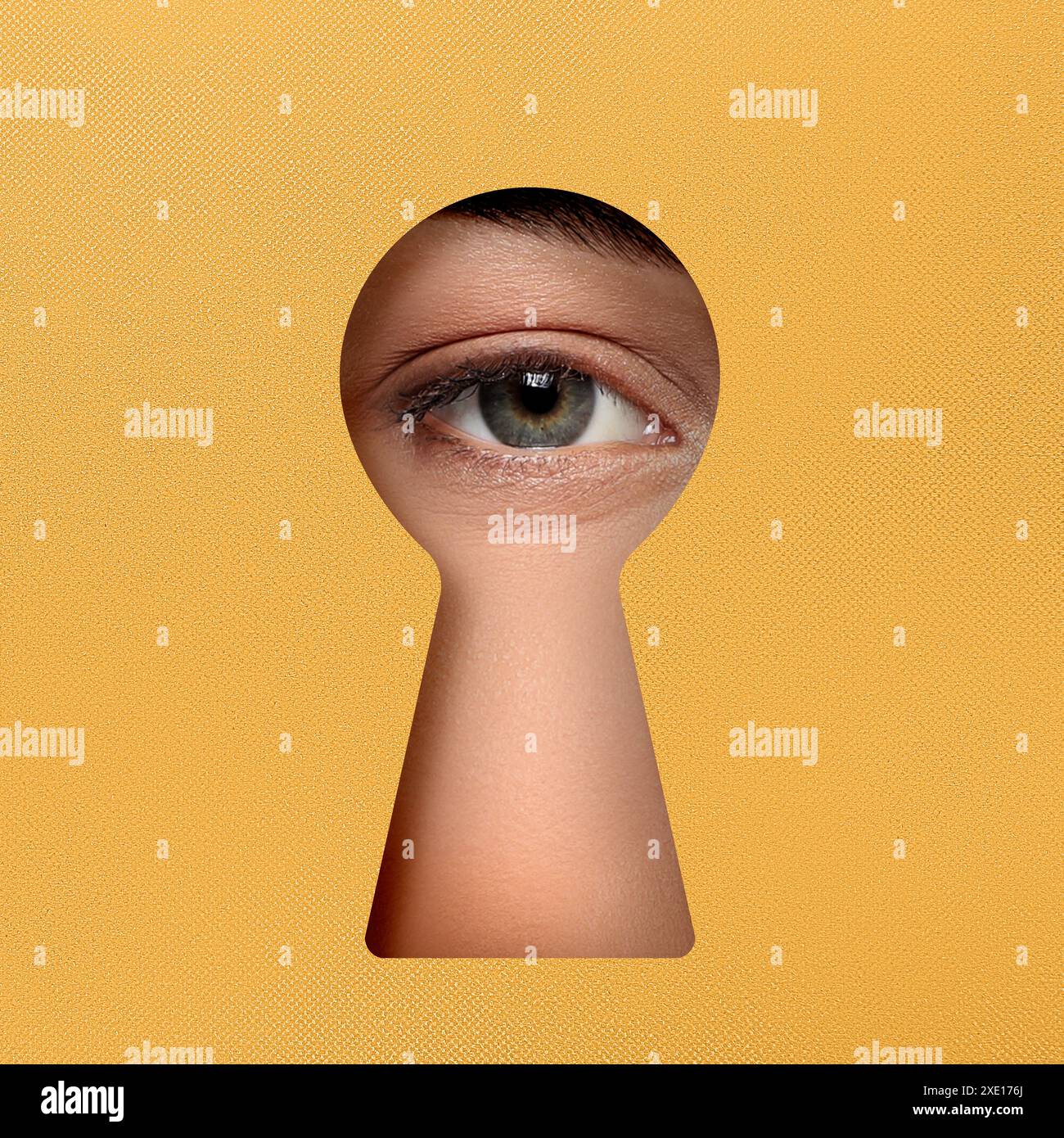 Woman looking through keyhole in golden surface Stock Photo - Alamy