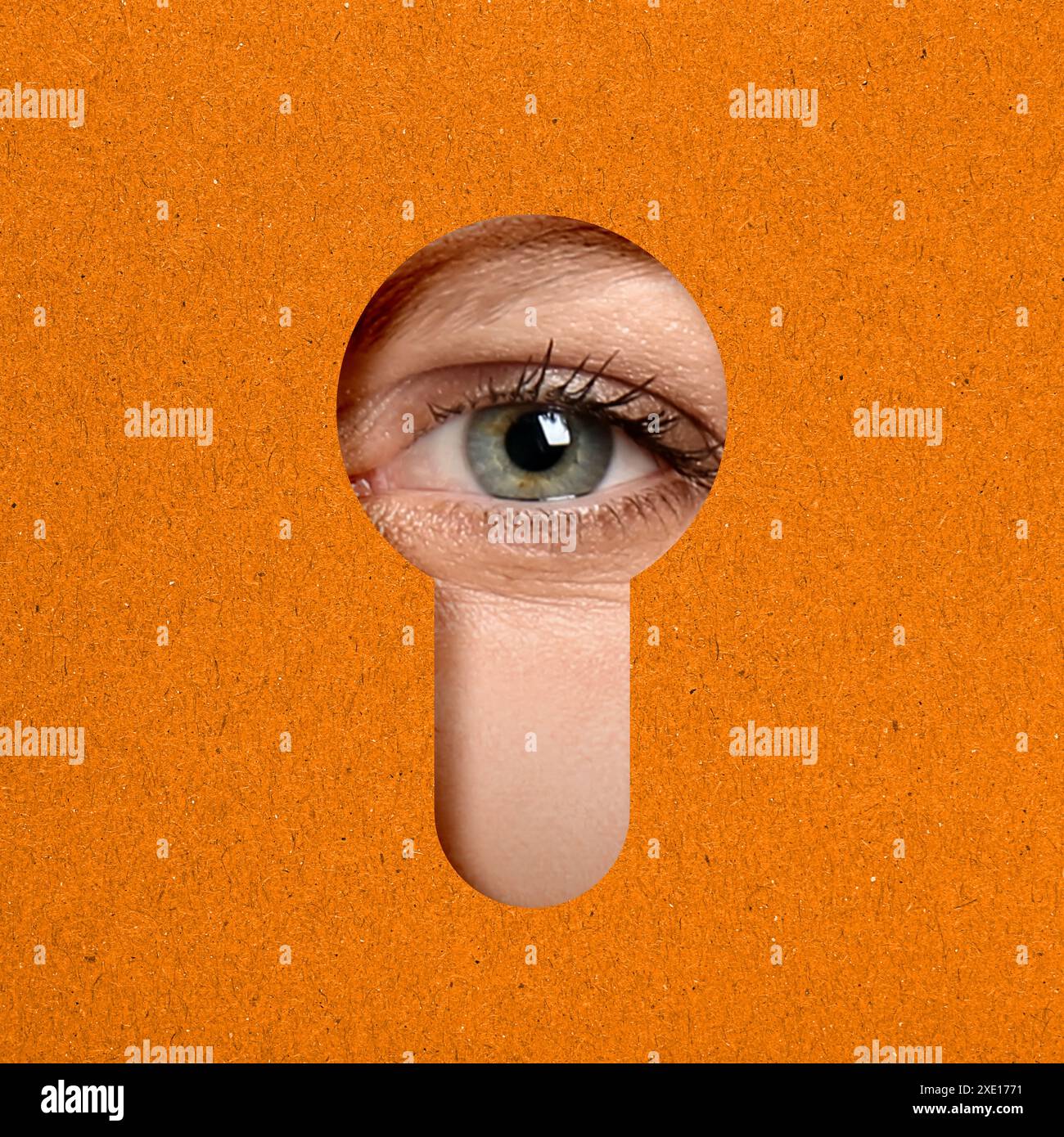 Woman looking through keyhole in orange surface Stock Photo - Alamy
