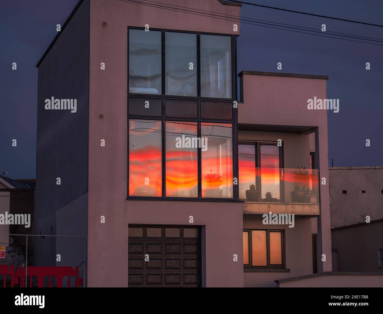 Sunset sky reflecting on windows opposite Rush Harbour Stock Photo - Alamy