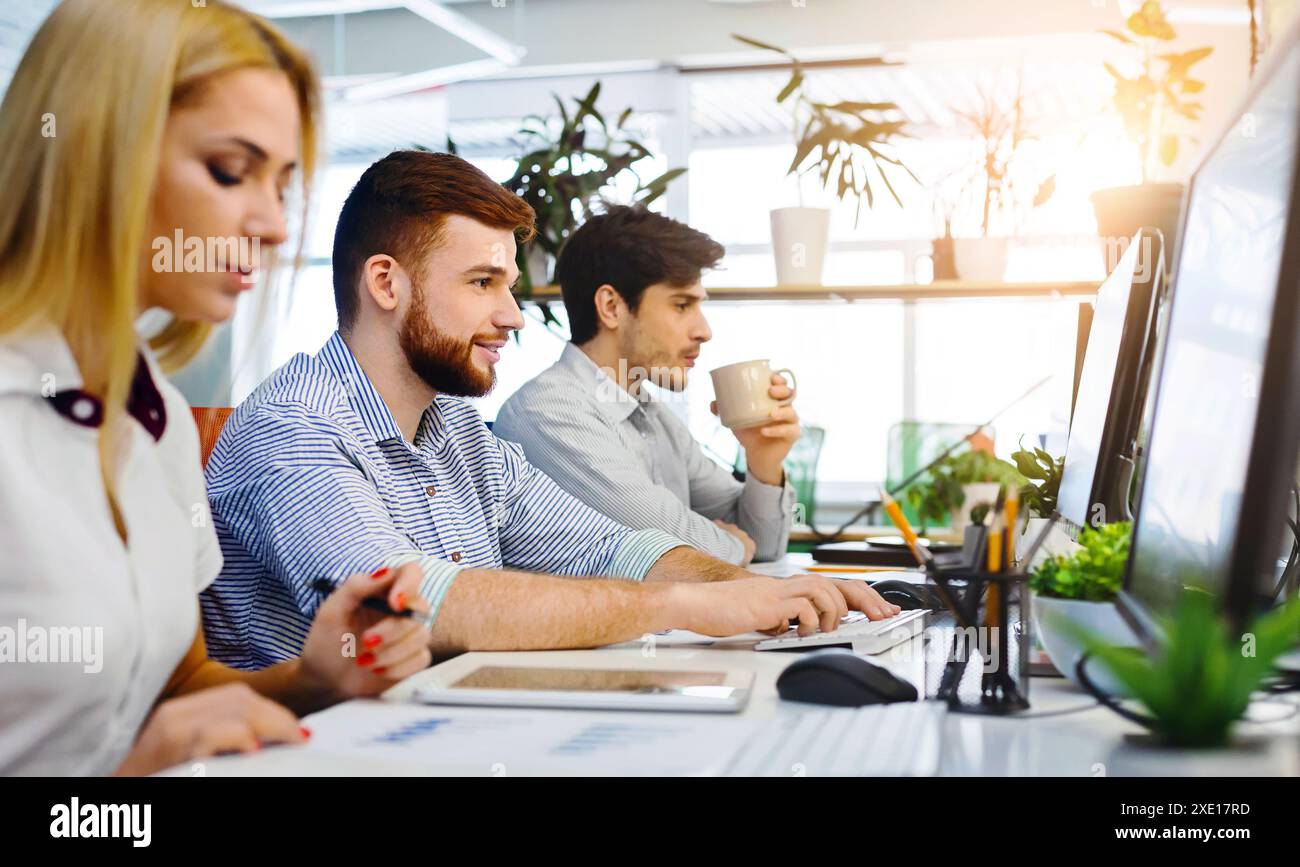 Young millennial people working on computers at coworking Stock Photo ...