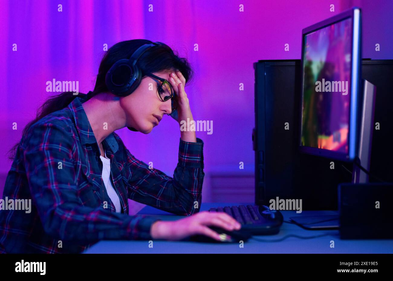 Exhausted Female Gamer Playing Video Games At Night Stock Photo - Alamy