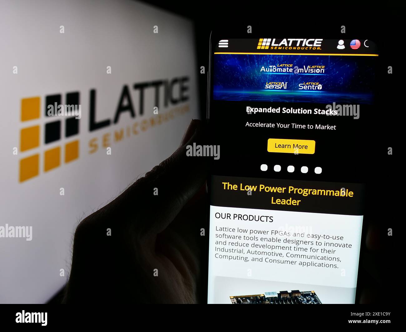 Person holding cellphone with webpage of US company Lattice ...