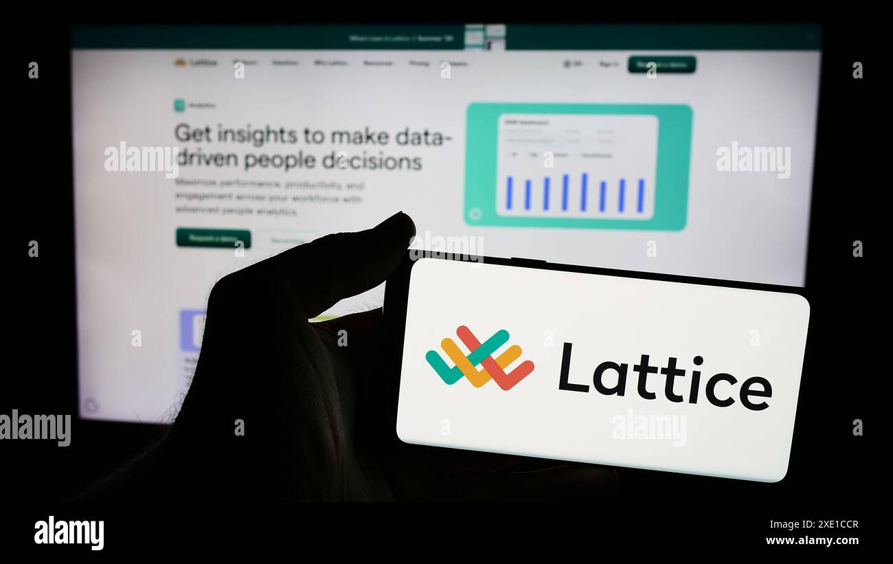 Person holding mobile phone with logo of American HR software company Degree Inc. (Lattice) in ...