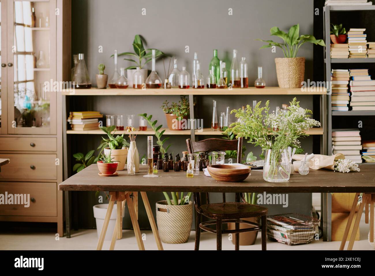 Wooden table with perfumery items and testers, shelves full of bottles ...