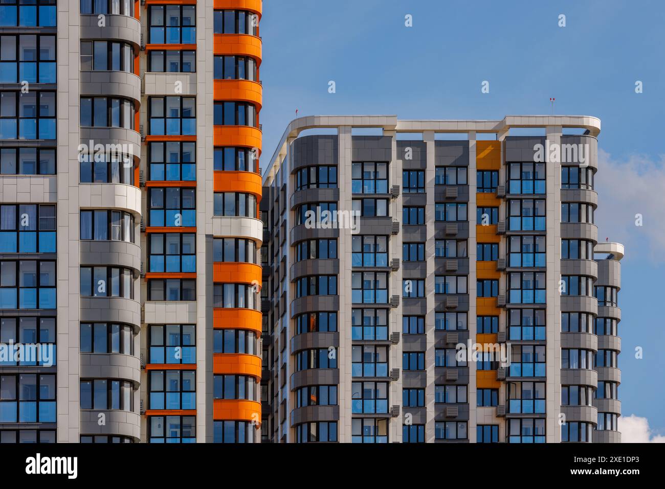 Freshly built high rise apartment buildings on blue sky background with ...