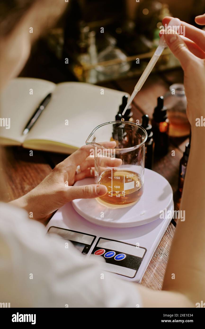 Medium close up of crystal flask with aromatic caramel liquid on ...