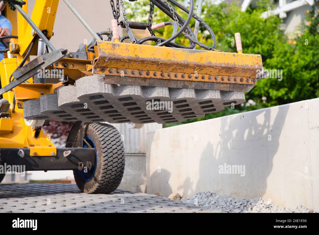 Construction machine lays concrete grass pavers on the construction ...