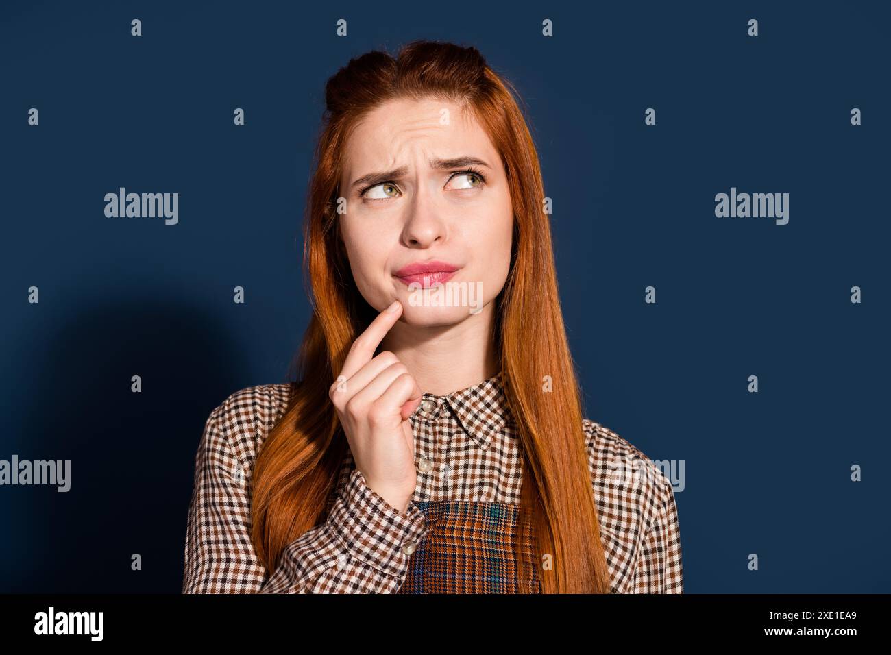 Photo of funky doubtful lady dressed plaid outfit finger chin looking ...