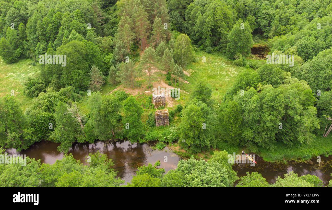 Top view of green forest with trees and river Merkys, railway bridge ...