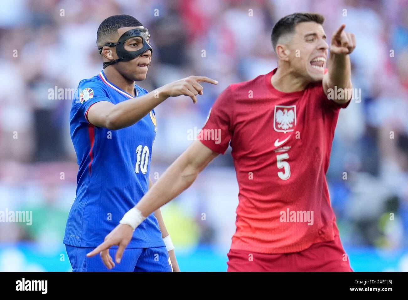 France's Kylian Mbappe (left), wearing a Black Mask after breaking his ...