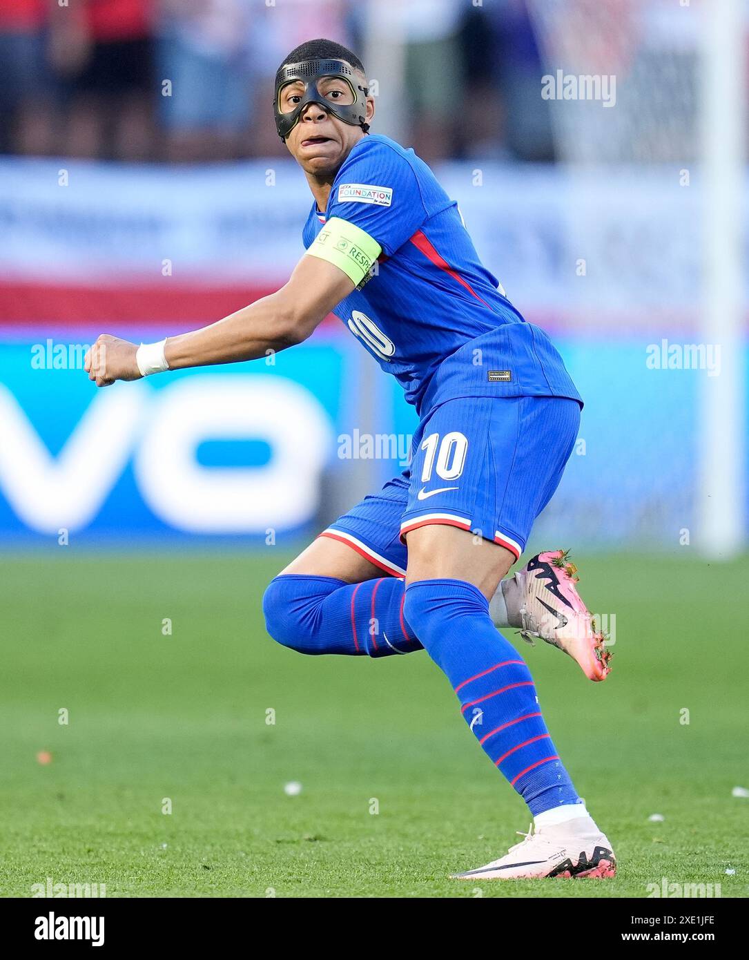 France's Kylian Mbappe, wearing a protective black mask after breaking ...