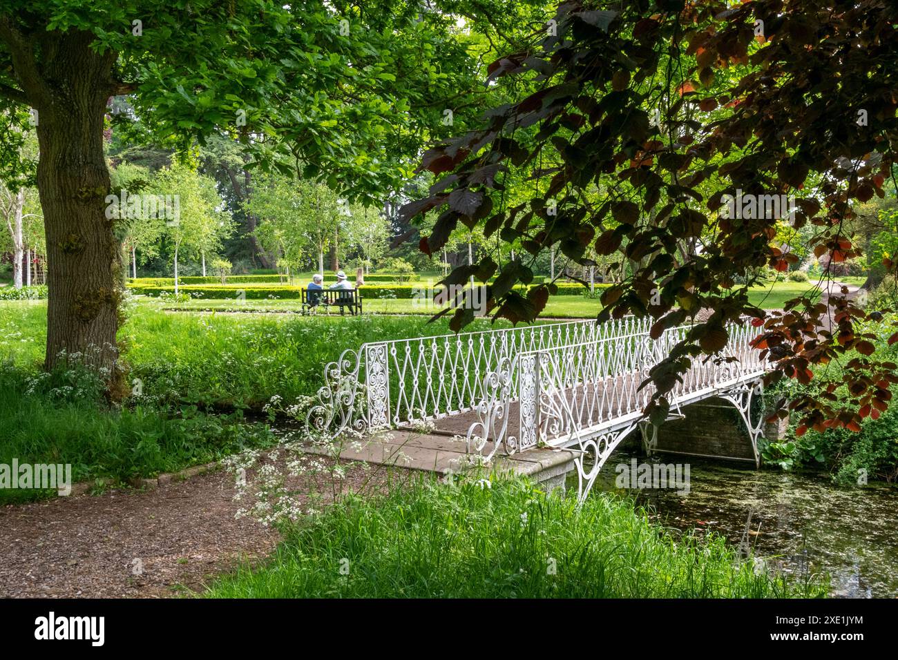 A footbridge over a river in a garden setting Stock Photo - Alamy
