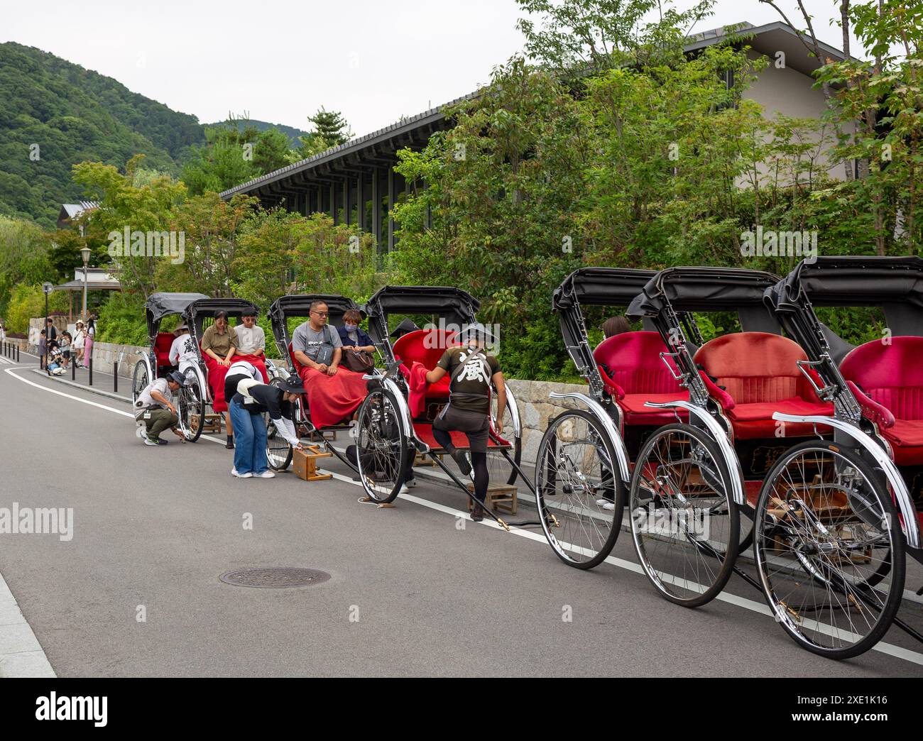Tourists seen sitting on the Jinrikisha cart in the Arashiyama area of ...