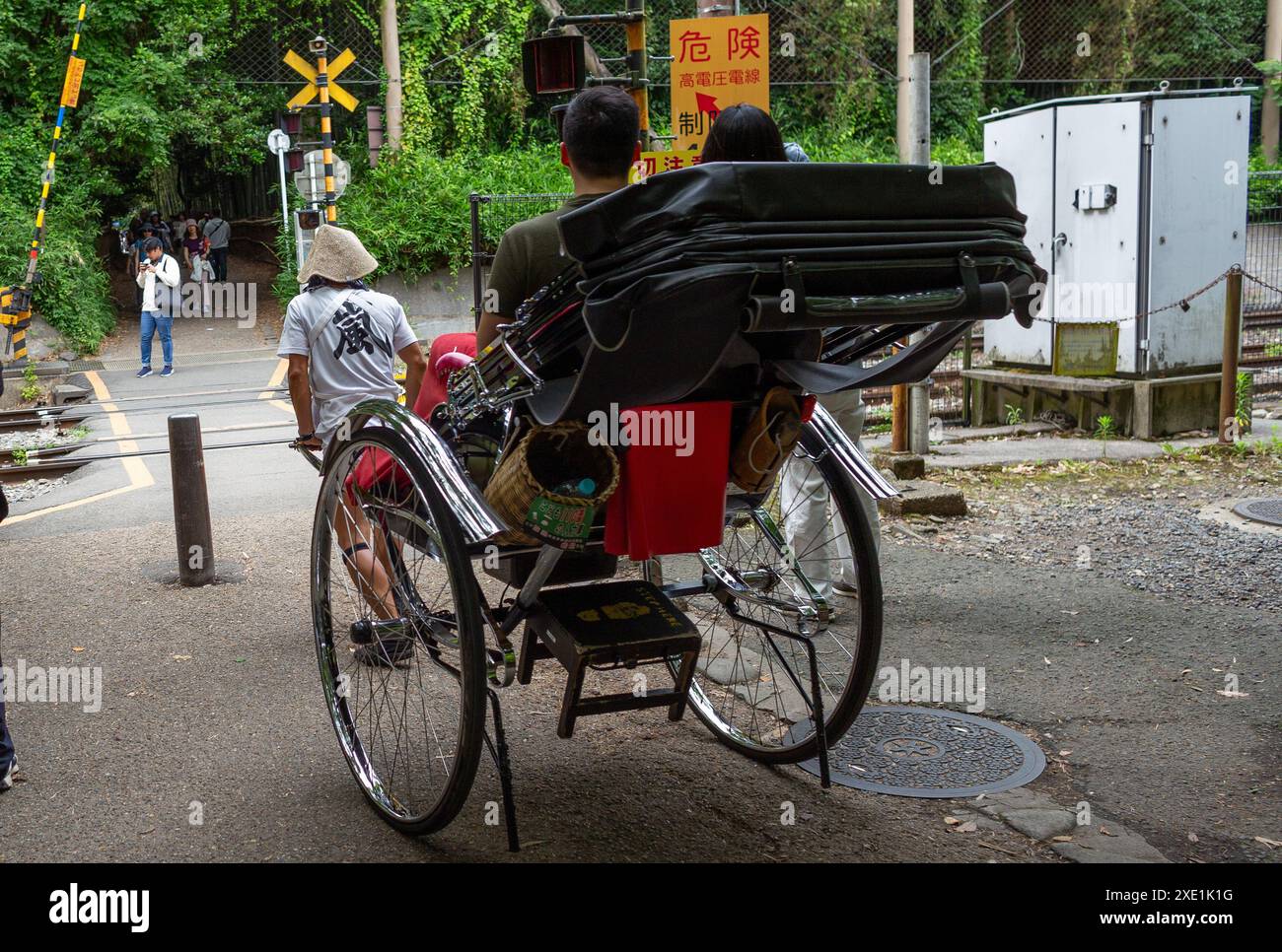 Tokyo, Japan. 25th June, 2024. A rickshaw rider pulls the Jinrikisha ...