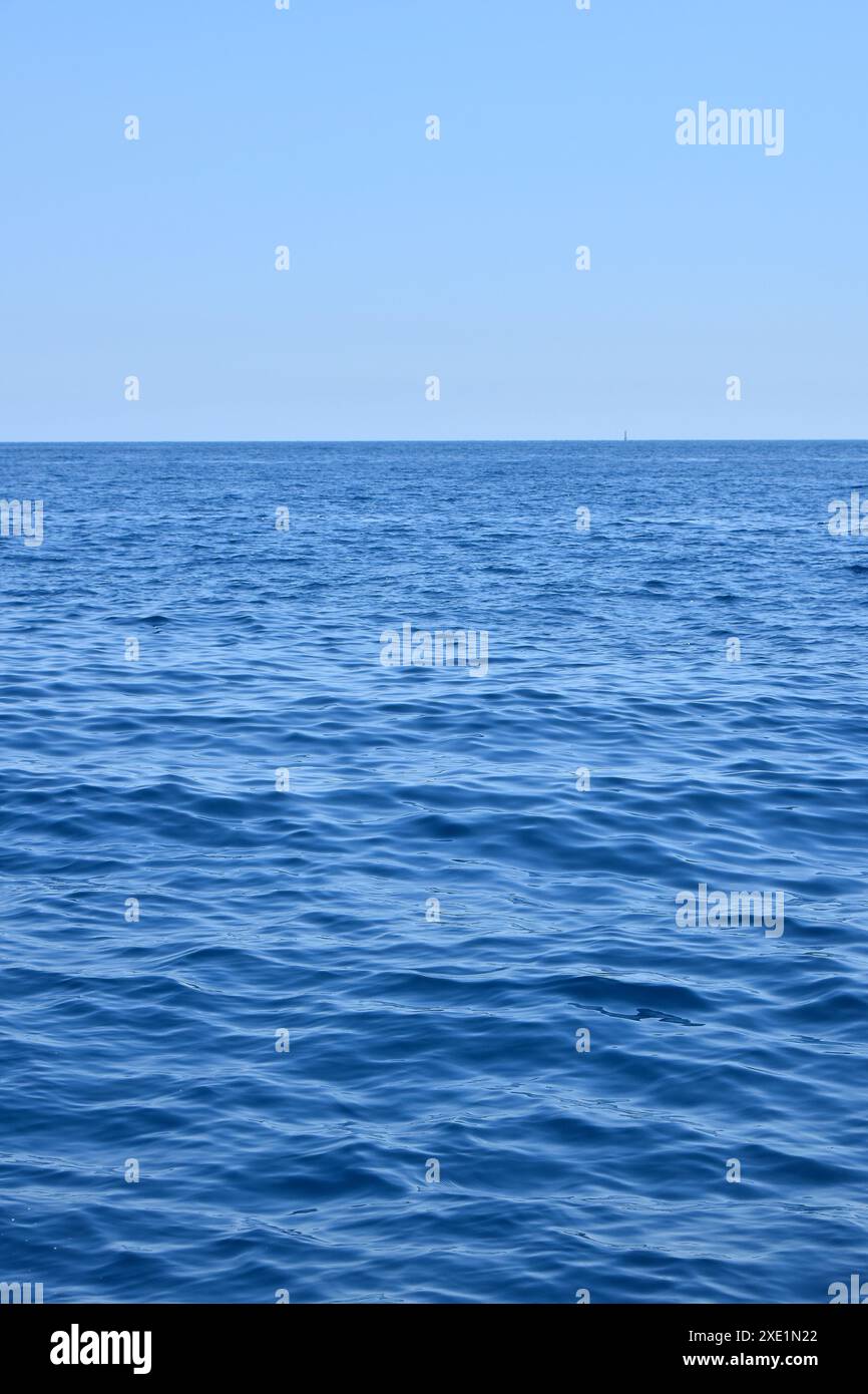Seascape with water ripples and clear blue sky Stock Photo - Alamy