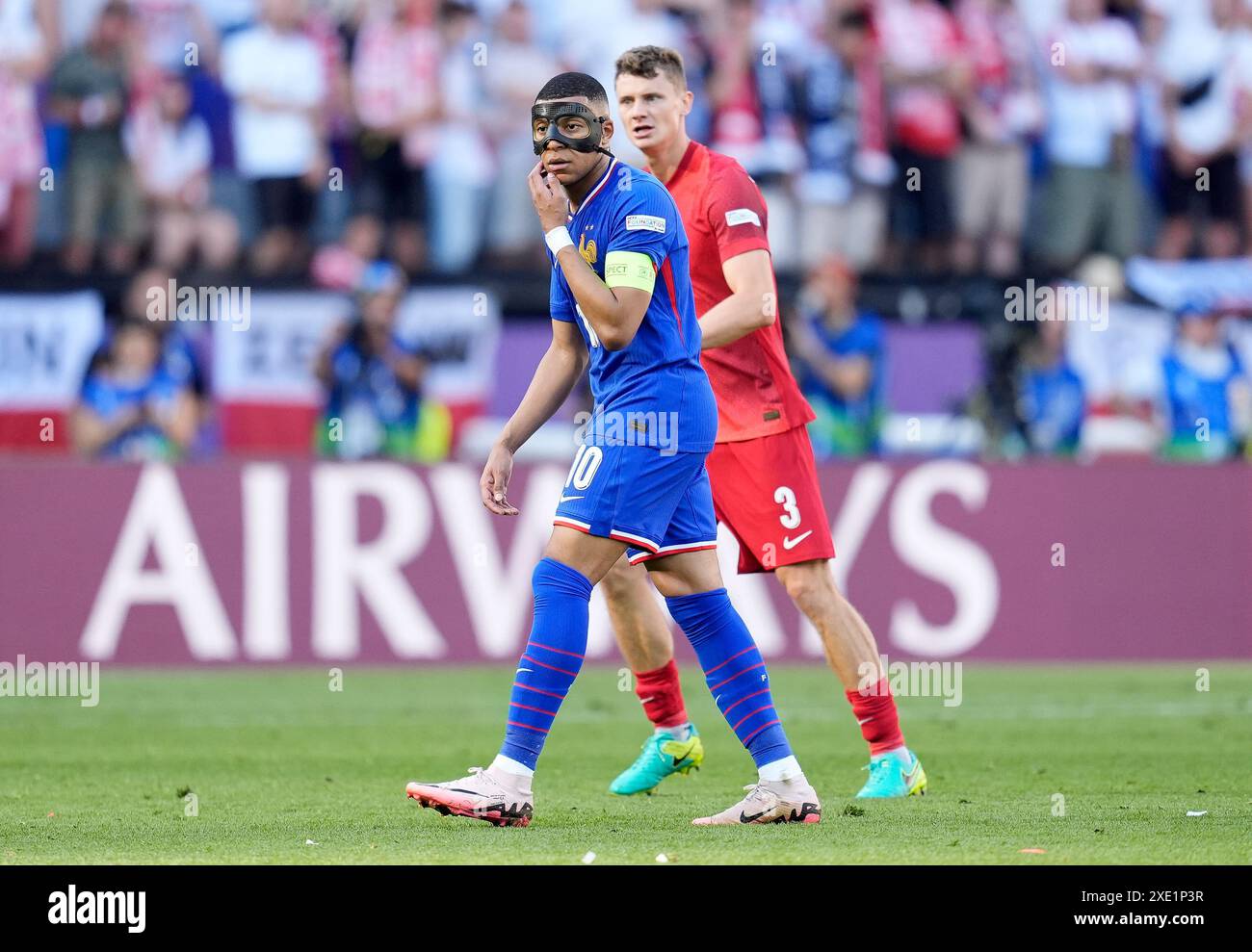 France's Kylian Mbappe (left), wearing a protective black mask after ...