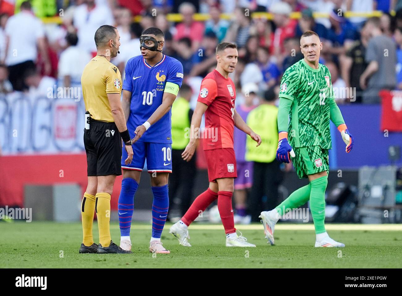 France's Kylian Mbappe, wearing a protective black mask after breaking ...