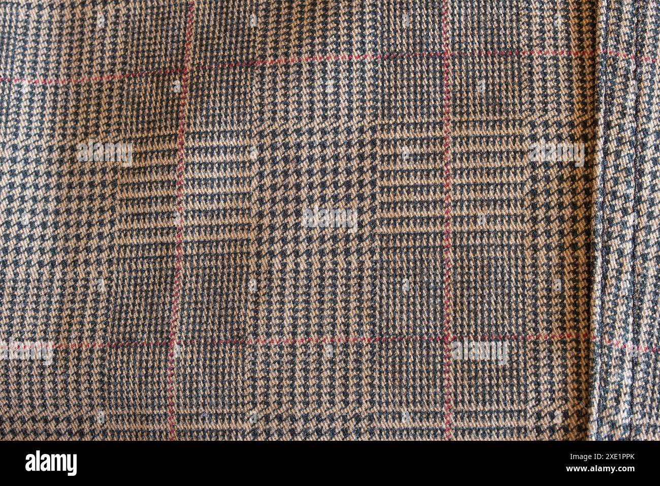 Close up of a classic checkered tweed blazer fabric, featuring a ...
